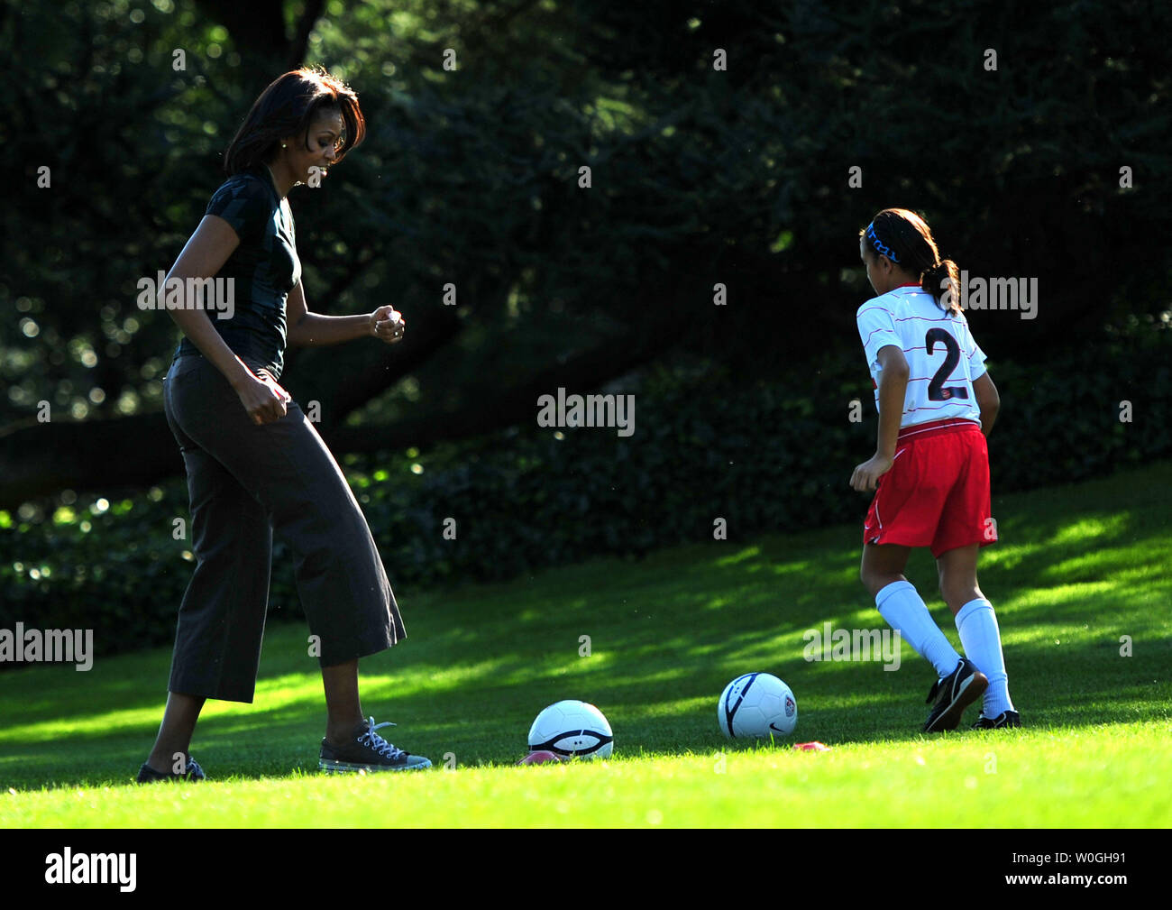 First Lady Michelle Obama plays soccer with children during a Let's ...
