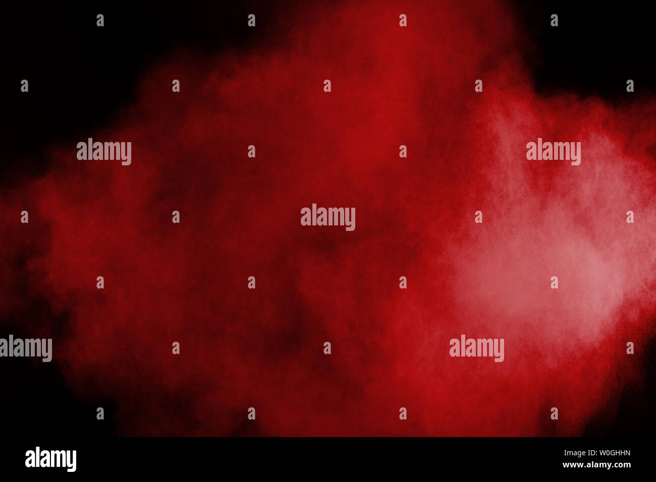 Red color powder explosion on black background. Freeze motion of red ...