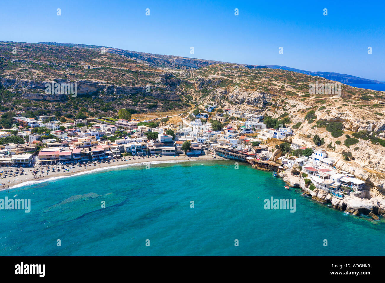 Matala beach with caves on the rocks that were used as a roman cemetery ...