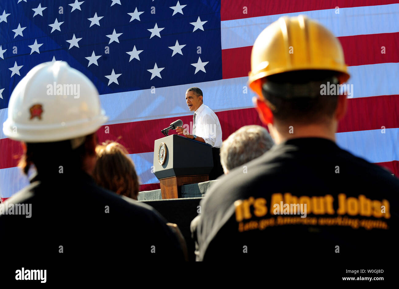 Construction workers listen as President Barack Obama delivers remarks ...
