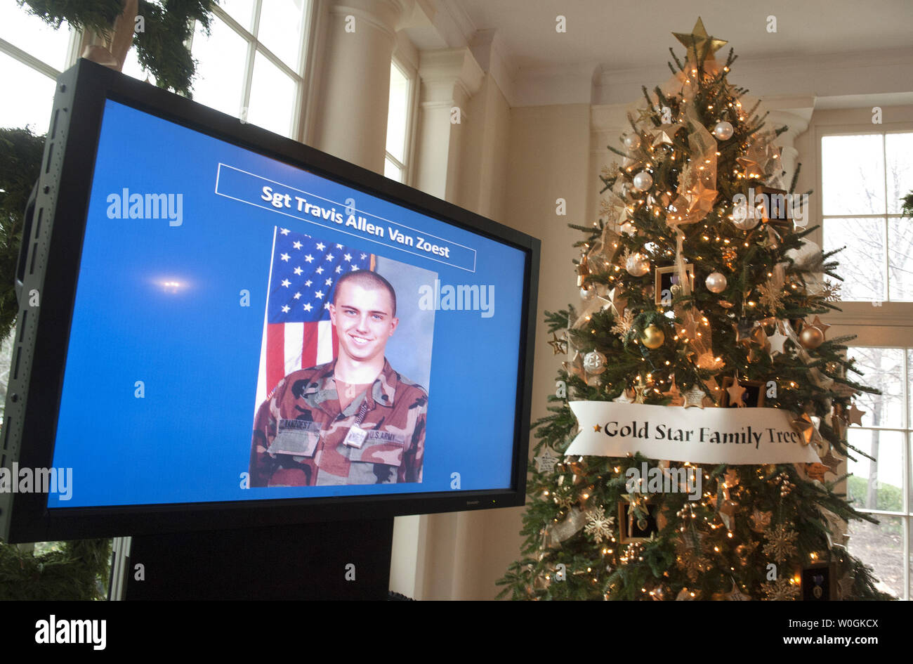 A photo of Sgt. Travis Allen Van Zoest is seen on a screen next to the ...
