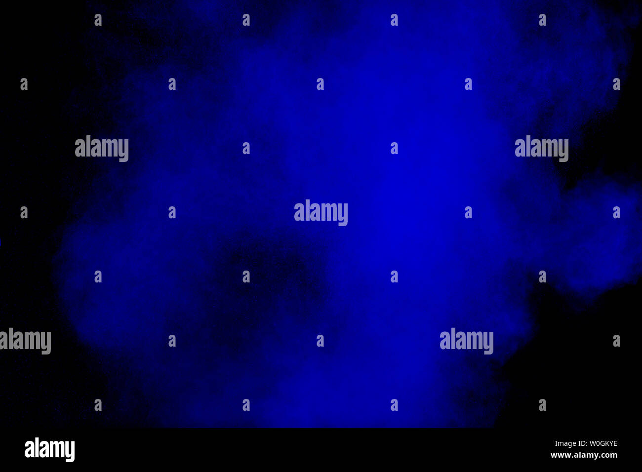 Blue color powder explosion cloud on black background.Closeup of Blue ...