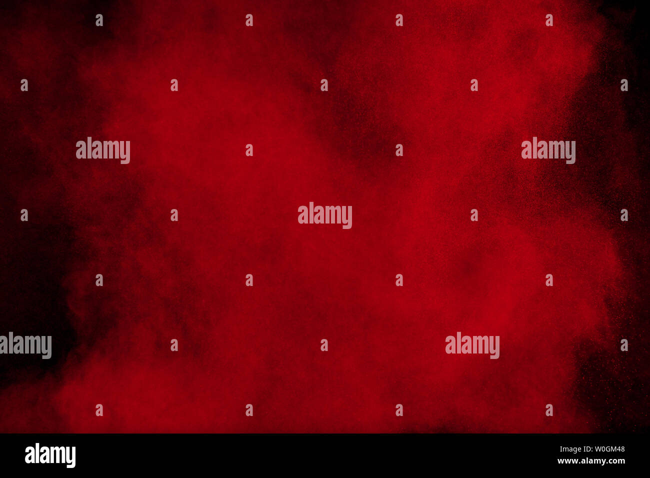 Red color powder explosion on black background. Freeze motion of red ...