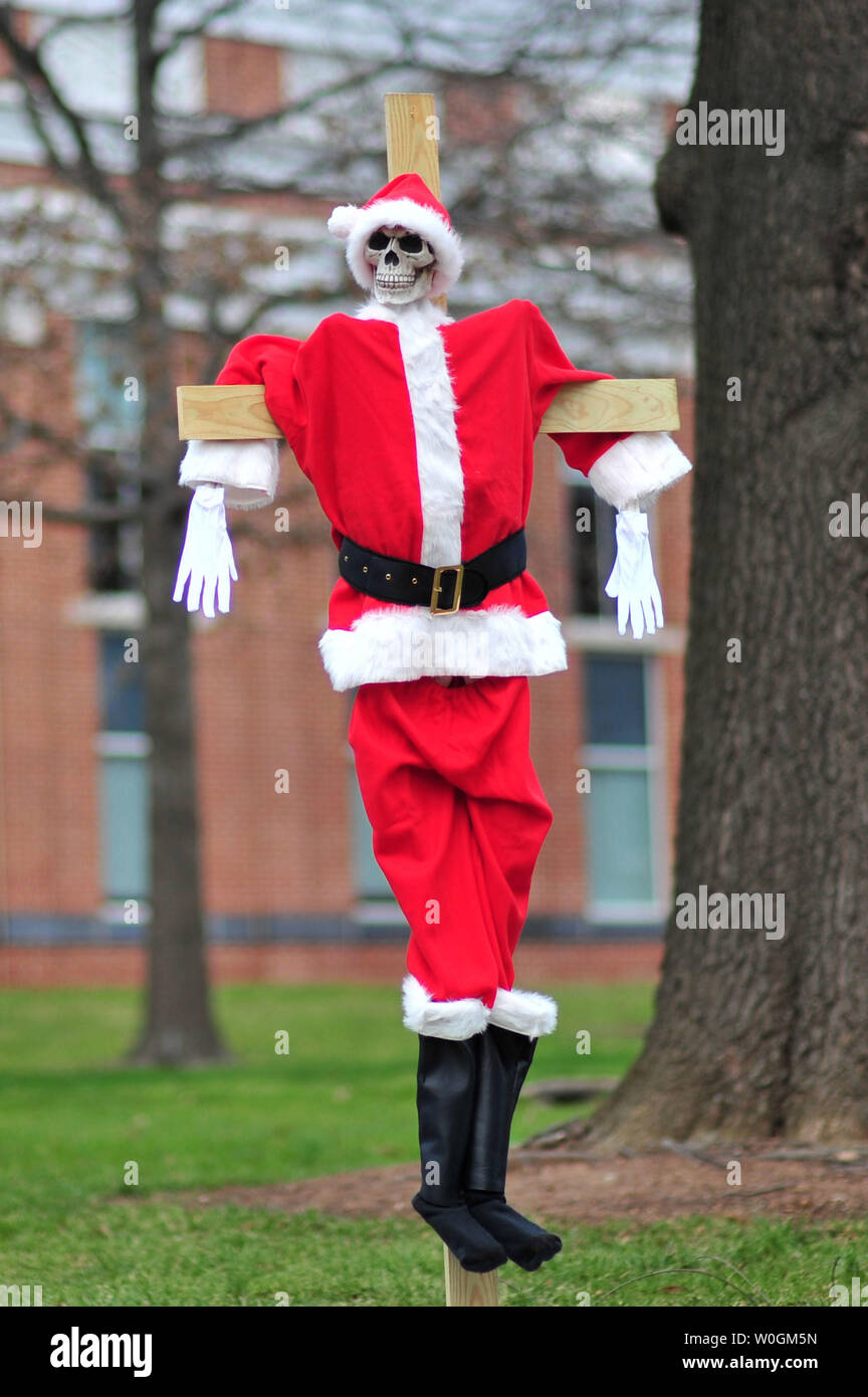 A skeleton dressed in a Santa Clause costume is seen hanging from a ...