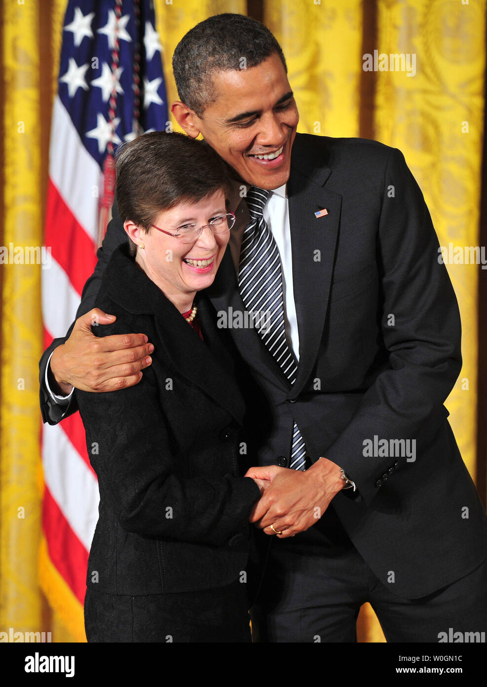 President Barack Obama embraces Cathy Gorn as he awards a National ...
