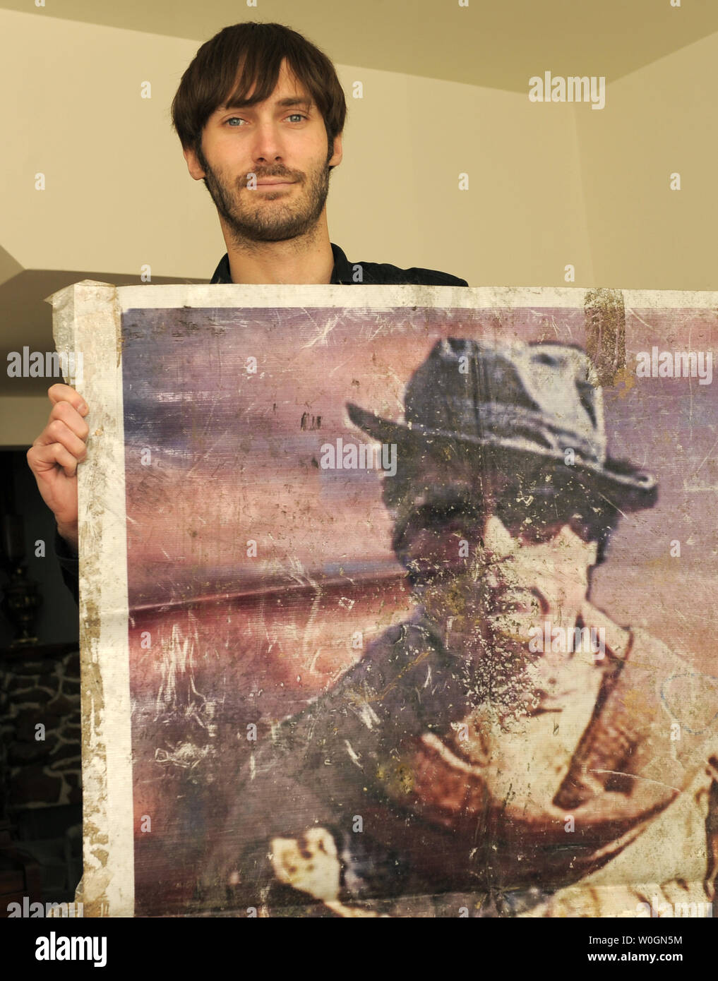 U.S. national Matthew VanDyke poses with a poster of former Libyan ...