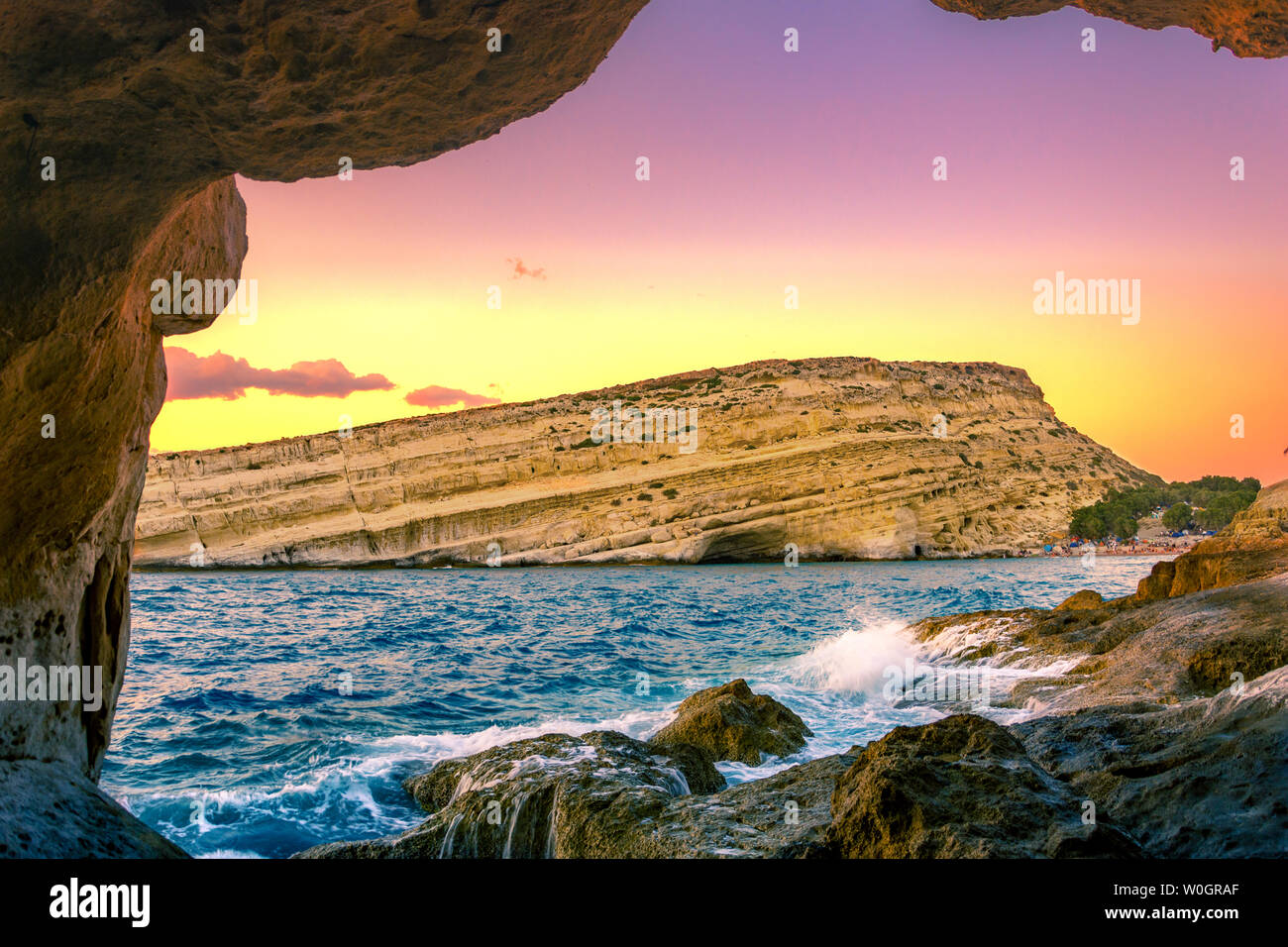 Matala beach with caves on the rocks that were used as a roman cemetery ...