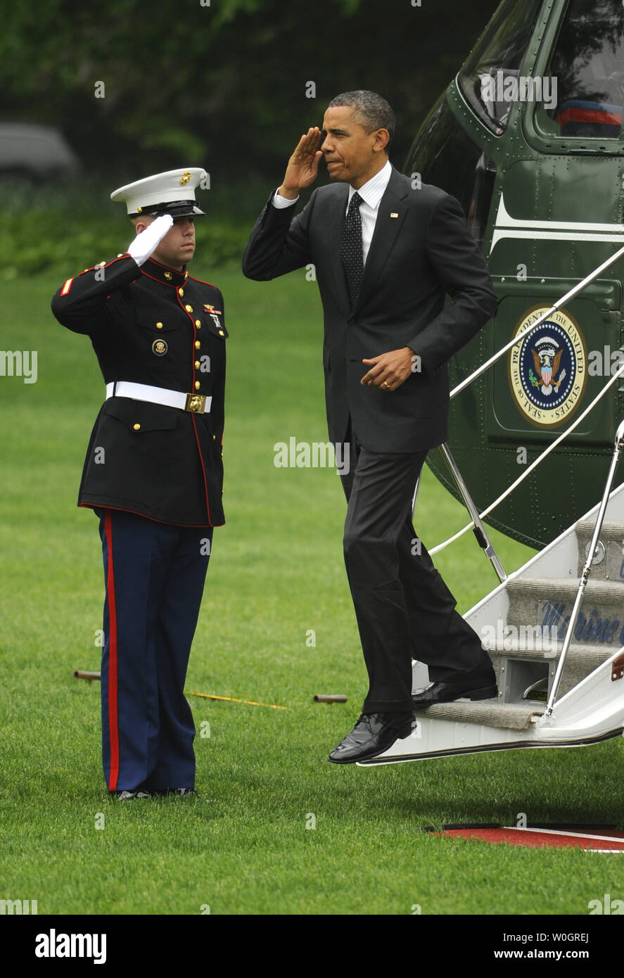 US President Barack Obama salutes a US Marine as he steps off Marine ...