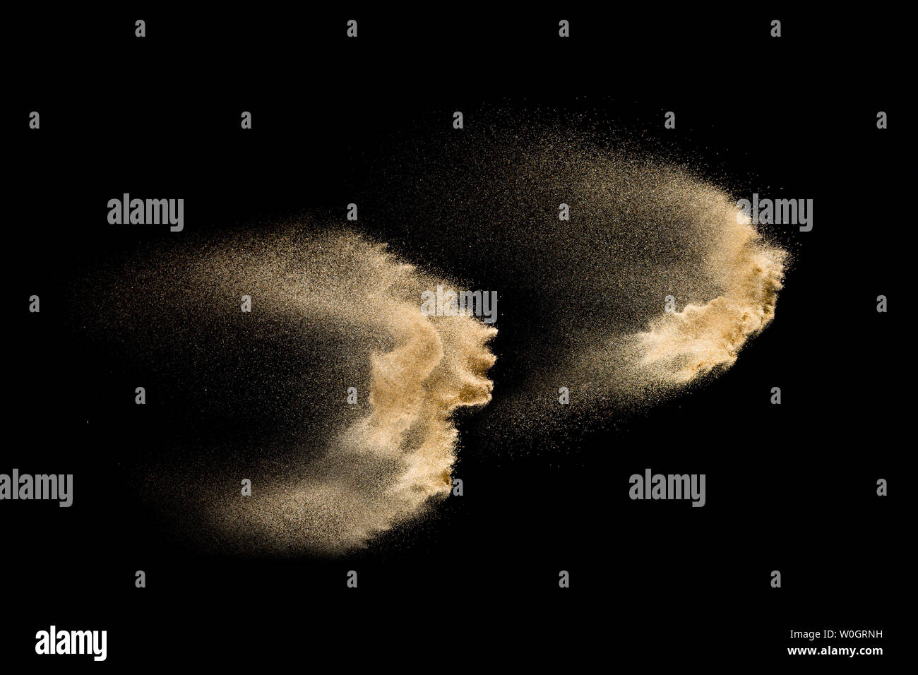 Dry river sand explosion. Golden colored sand splash against black ...