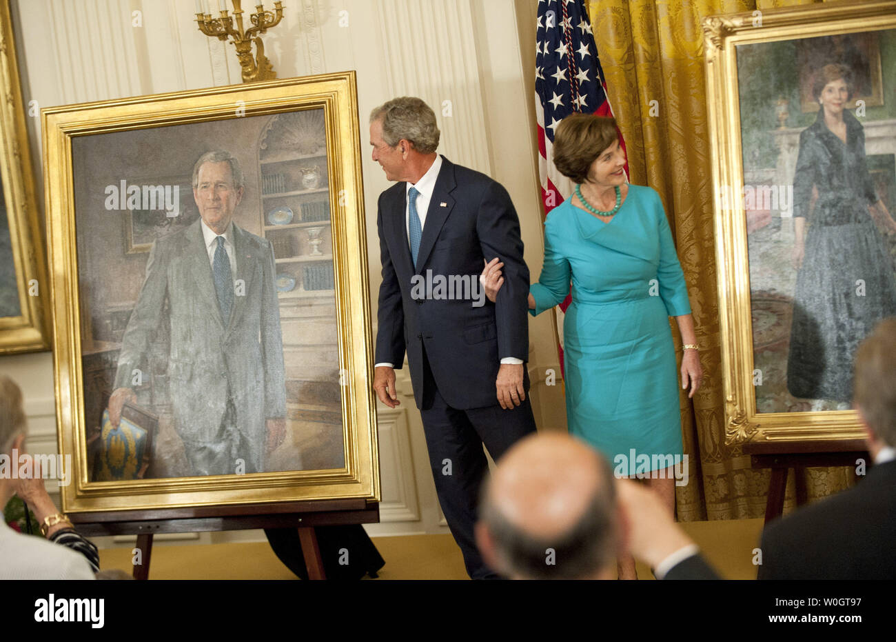 Former President George W. Bush and his wife Laura Bush look at their ...