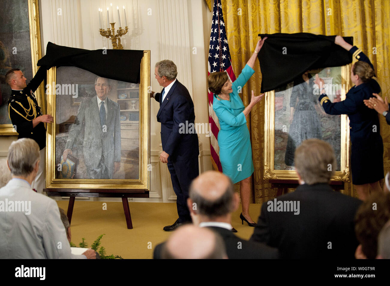 Former President George W. Bush and his wife Laura Bush look at their ...