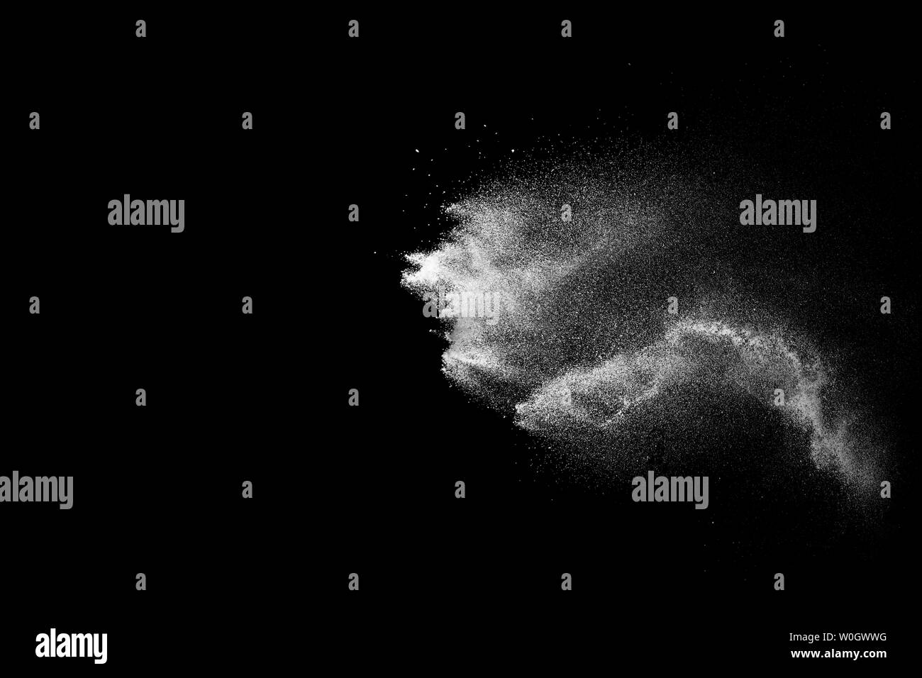 Freeze motion of white dust particles on black background. White powder ...