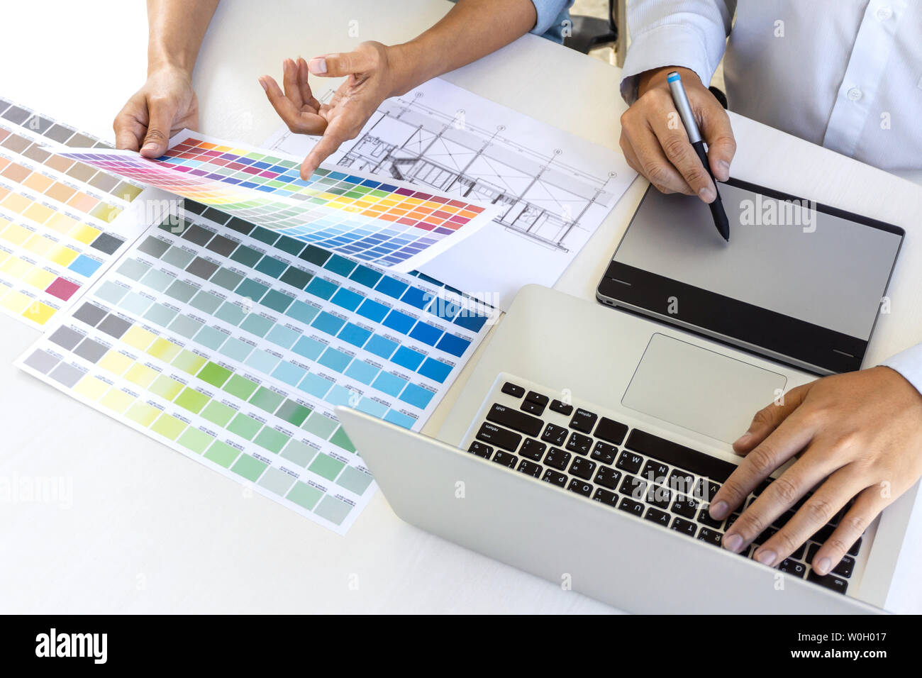 Team of colleague graphic designer drawing and retouching image on ...