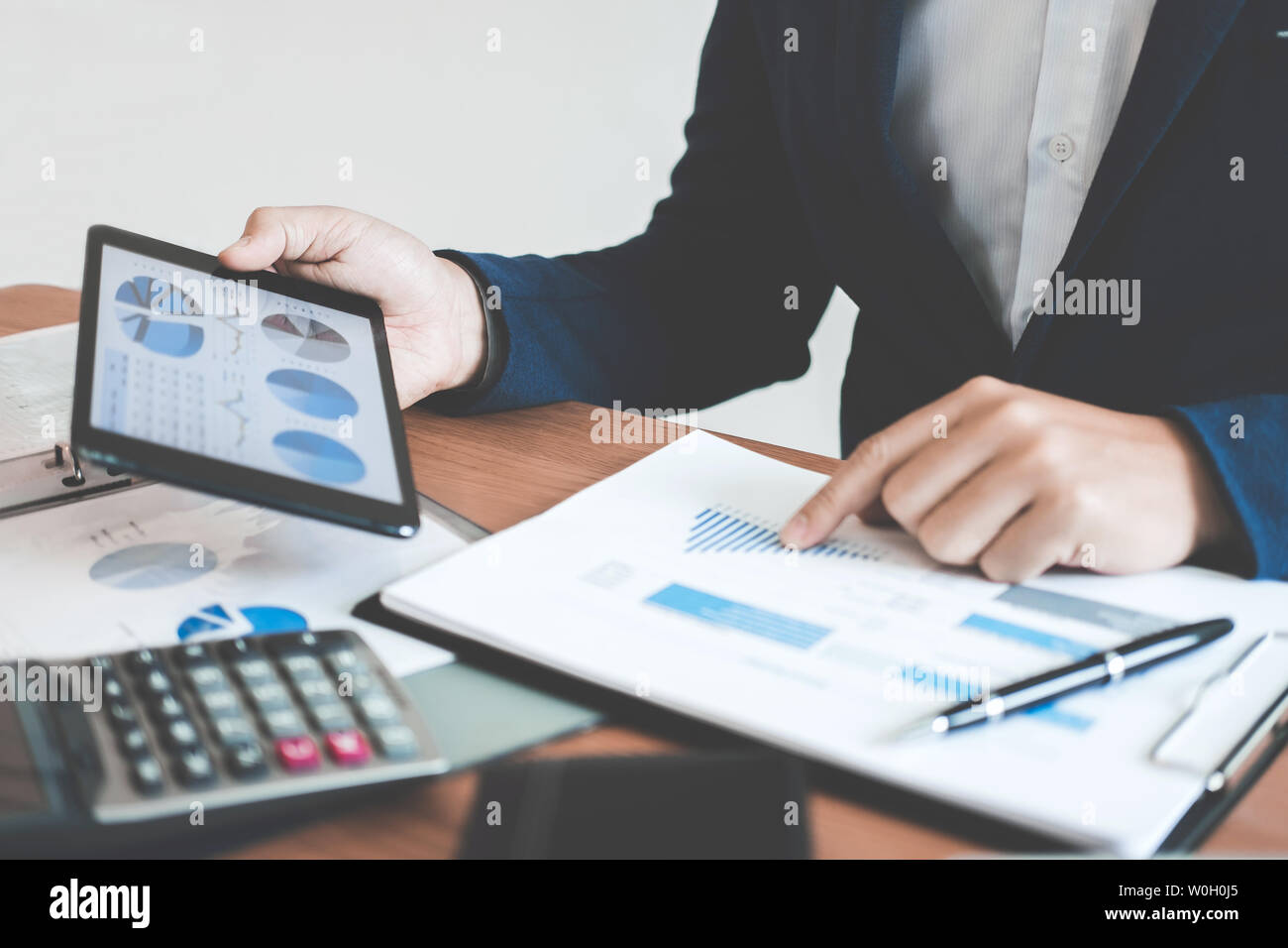 Businessman hands using text information on digital tablet to analyze ...
