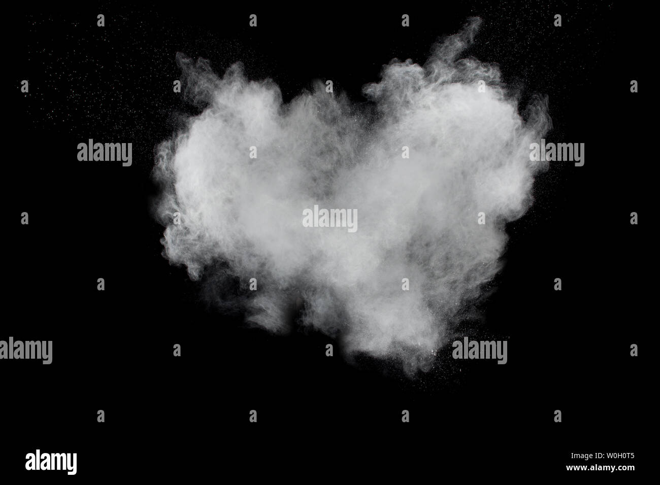 Bizarre forms of white powder explosion cloud against black background ...