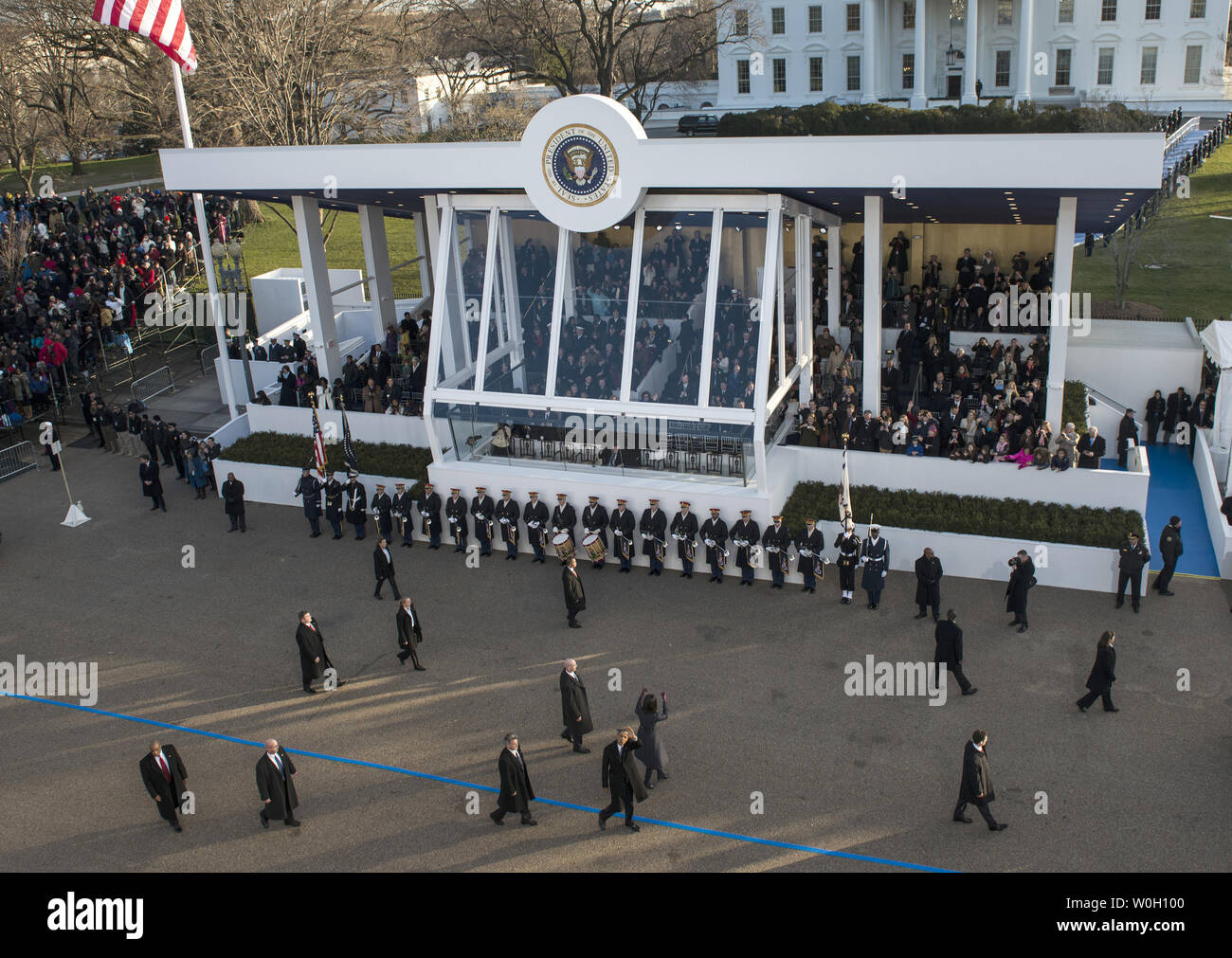 President Barack Obama and First Lady Michelle Obama walk past the ...