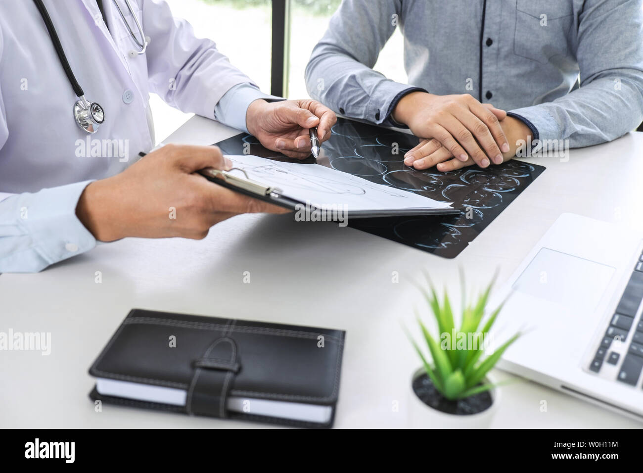 Professor Doctor having conversation with patient and holding x-ray ...