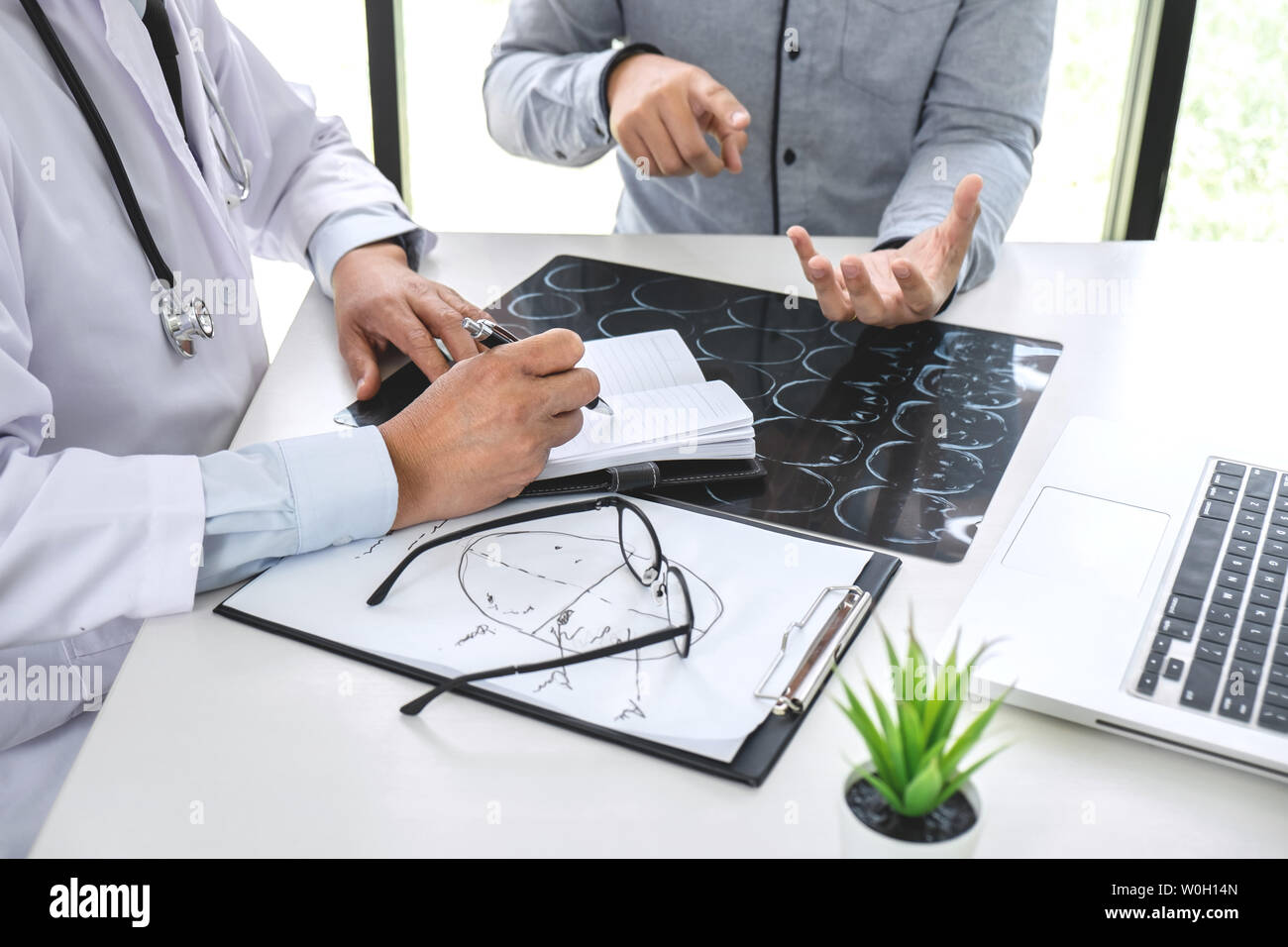 Professor Doctor recommend treatment method with patient and holding x ...