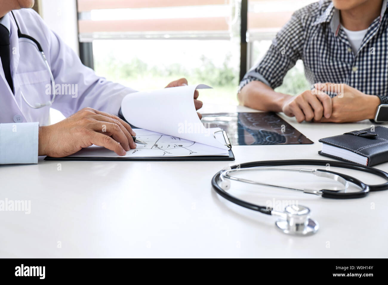 Professor Doctor recommend treatment method with patient and holding x ...