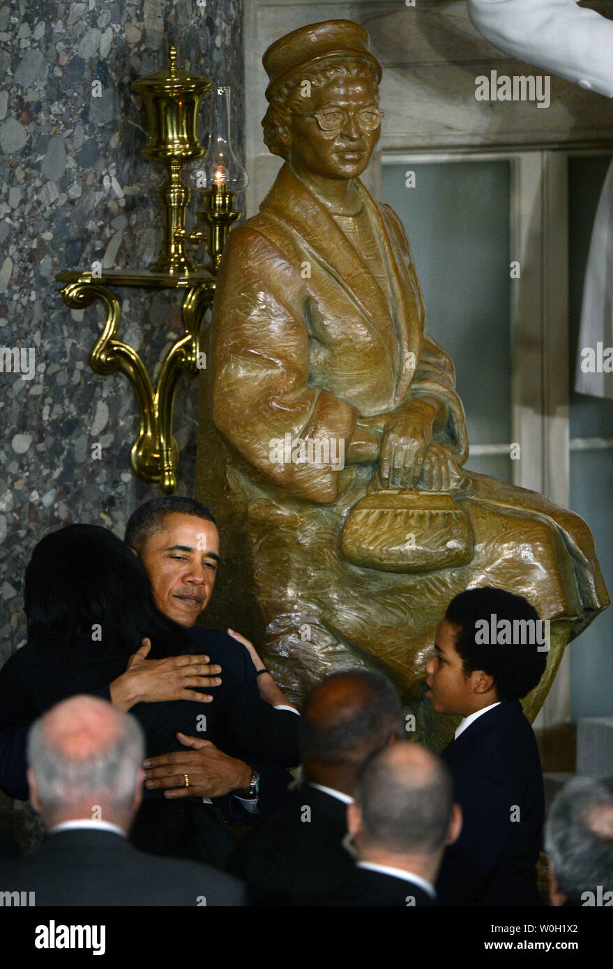 President Barack Obama hugs a woman during the unveiling ceremony for ...