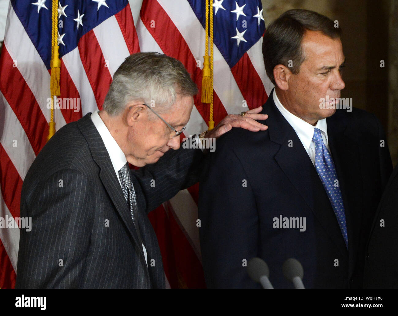 Senate Majority Leader Harry Reid (D-NV) puts his hand on Speaker of ...