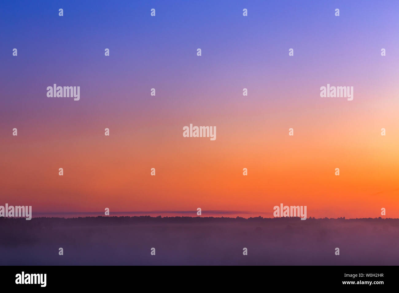 minmalistic foggy sky glow before sunrise without sun Stock Photo - Alamy