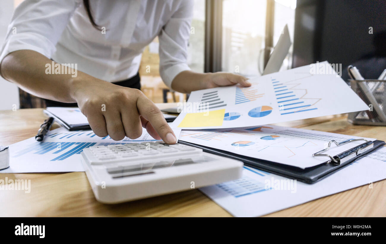 Business woman accountant working and calculating financial data on ...
