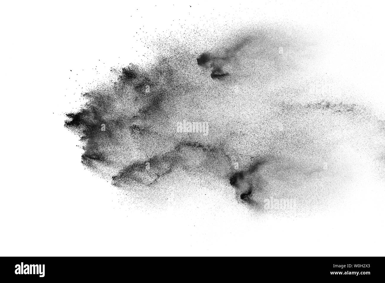 Black particles splattered on white background. Black powder dust ...