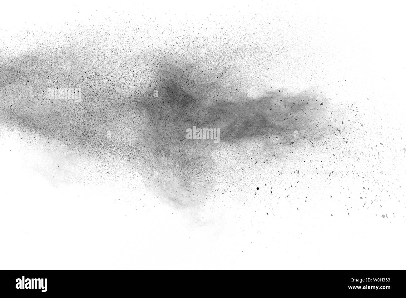 Black particles splattered on white background. Black powder dust ...