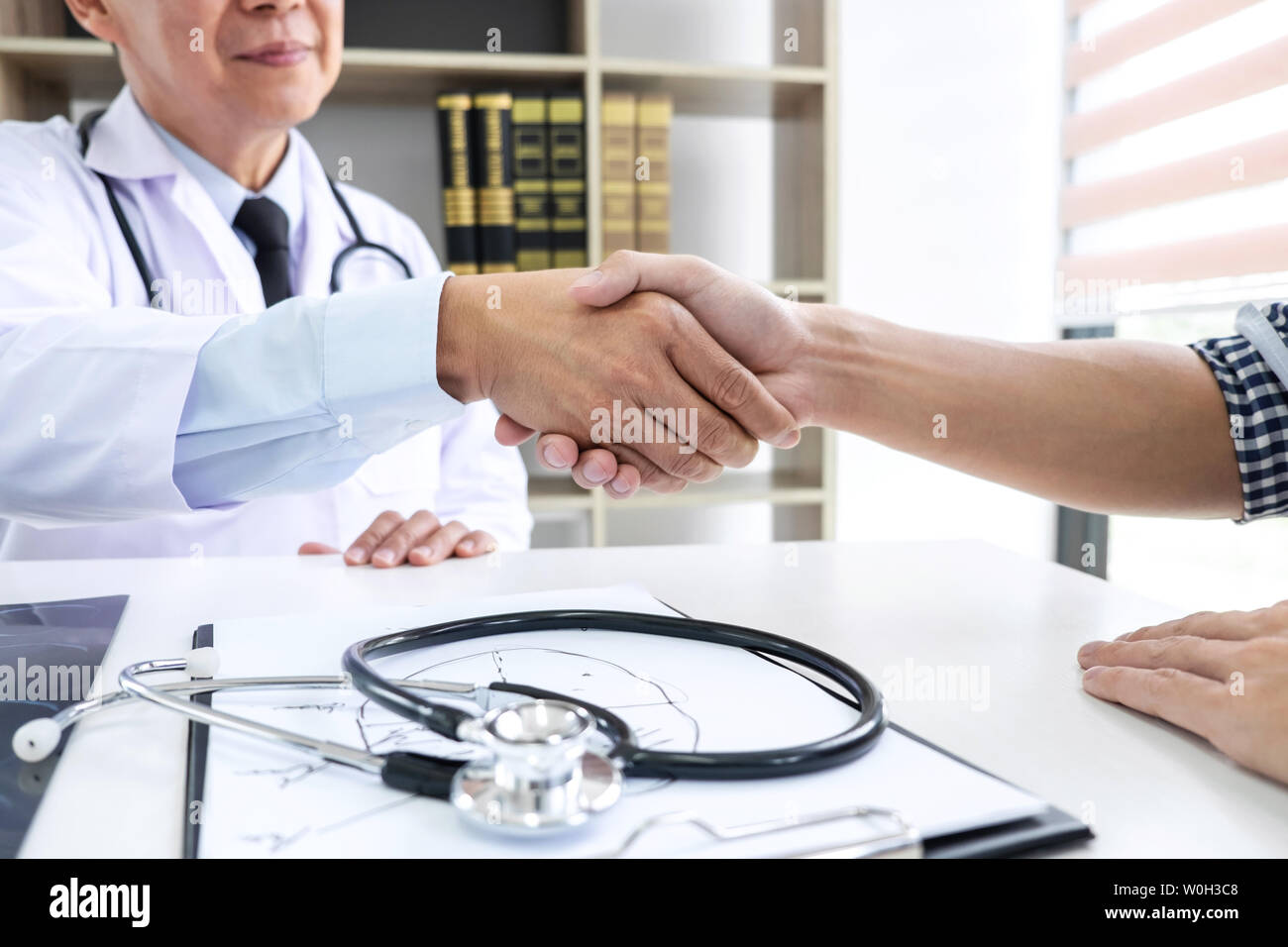 Professor Doctor having shaking hands with patient after recommend ...
