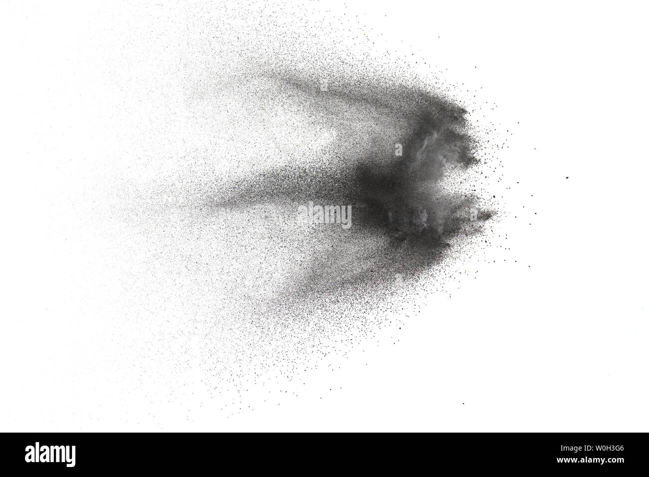 Black particles splattered on white background. Black powder dust ...