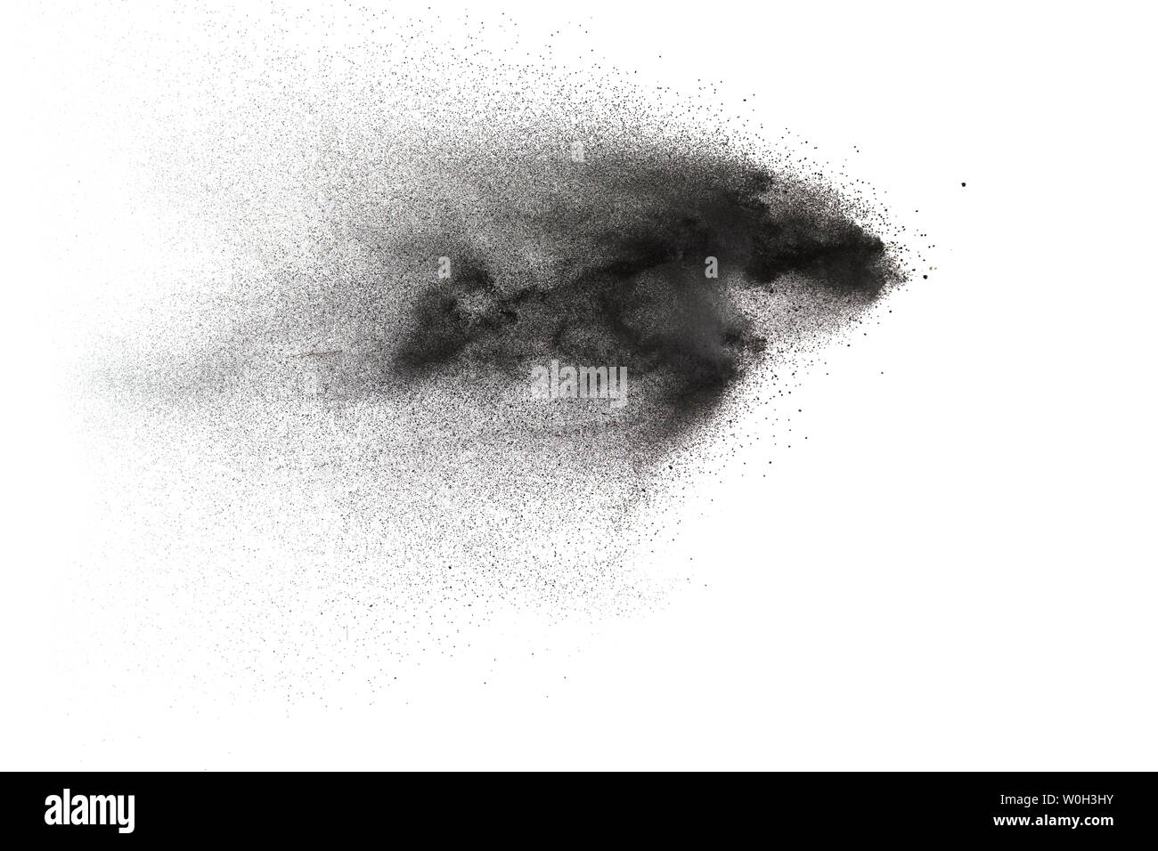 Black particles splattered on white background. Black powder dust ...