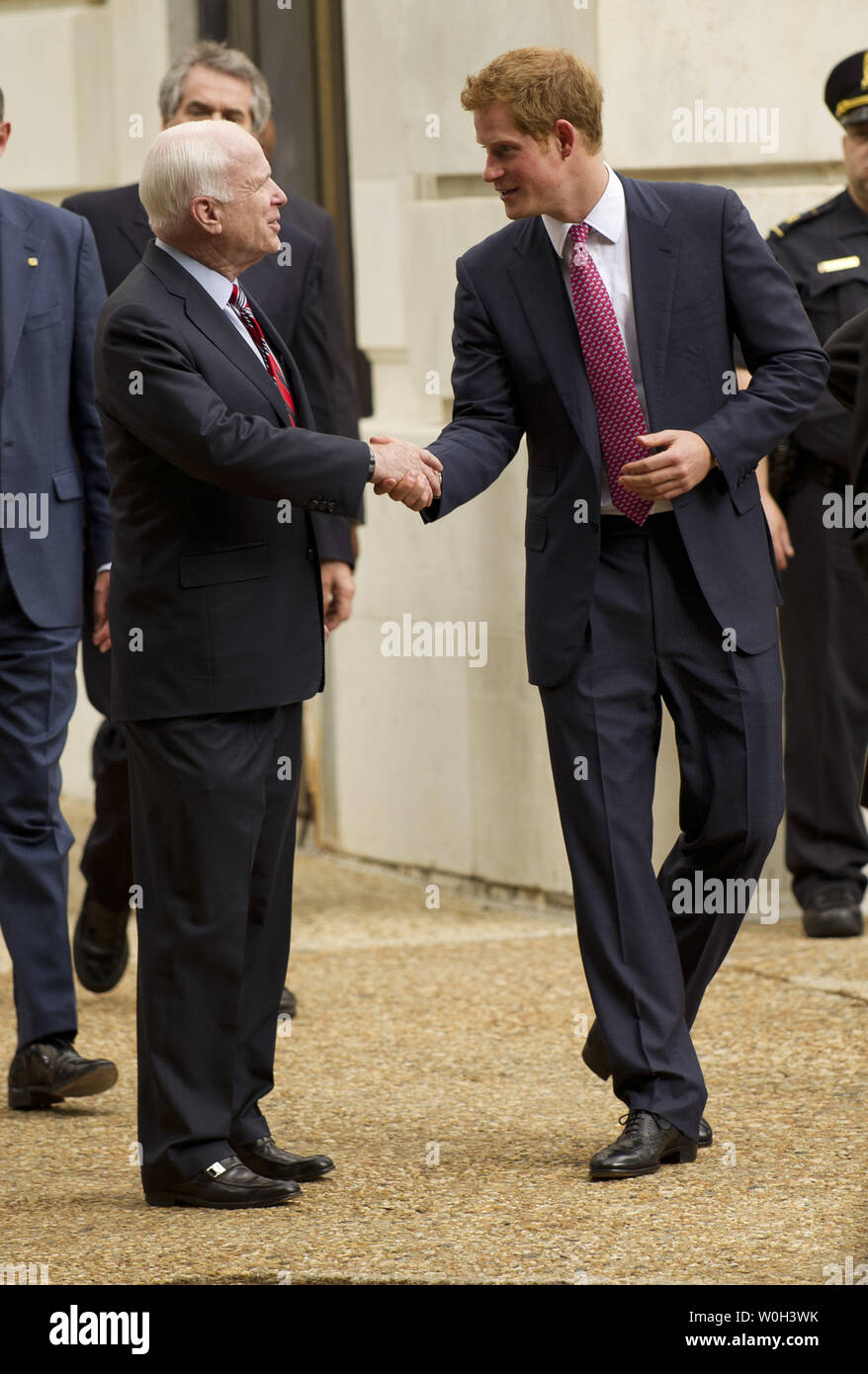 Prince Harry (R) shakes hands with Sen. John McCain (R-AZ) as he leaves ...