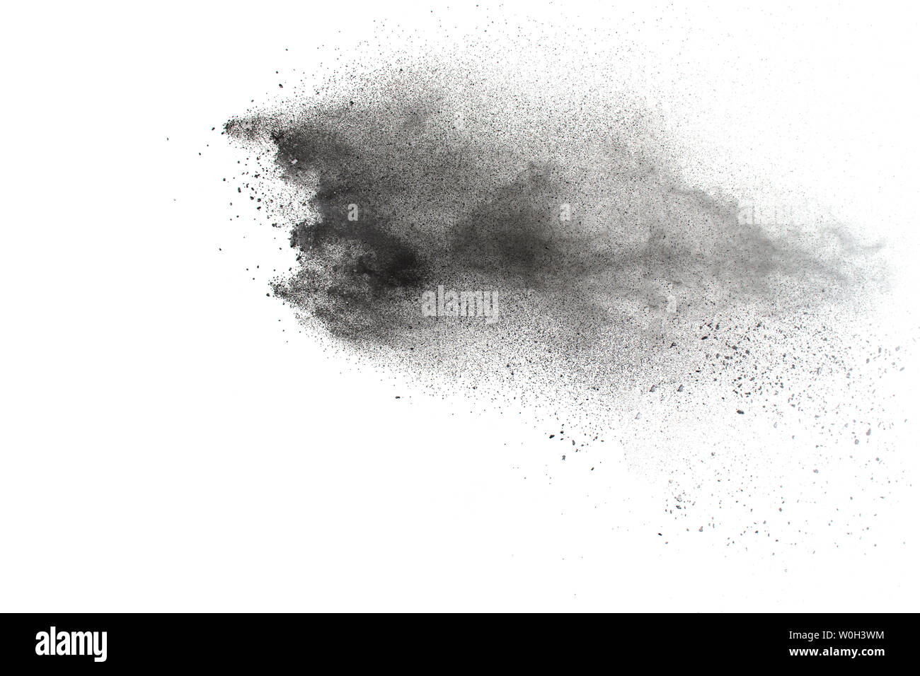 Black particles splattered on white background. Black powder dust ...