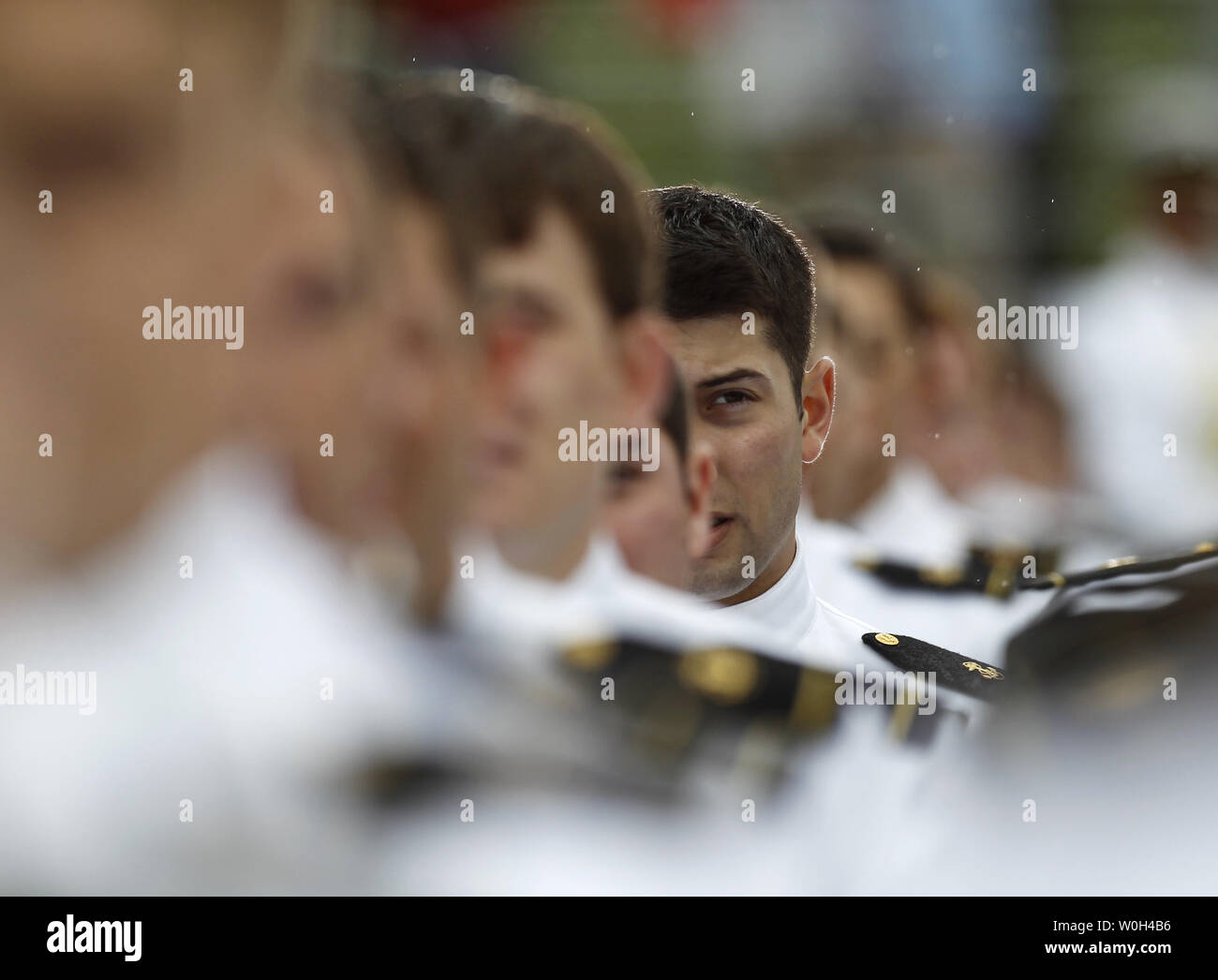 Midshipmen listen during the U.S. Naval Academy Graduation and ...