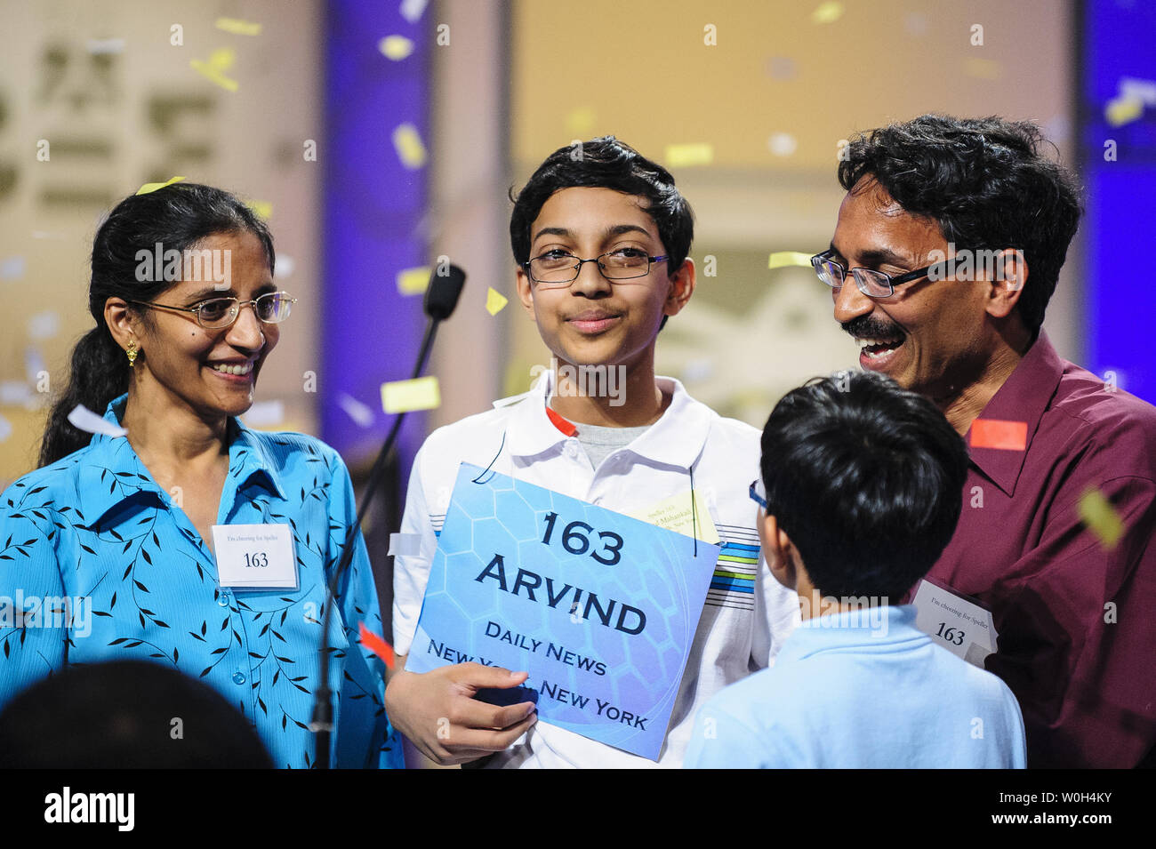 Arvind Mahankali, 13, of Bayside Hills, New York stands with his family ...