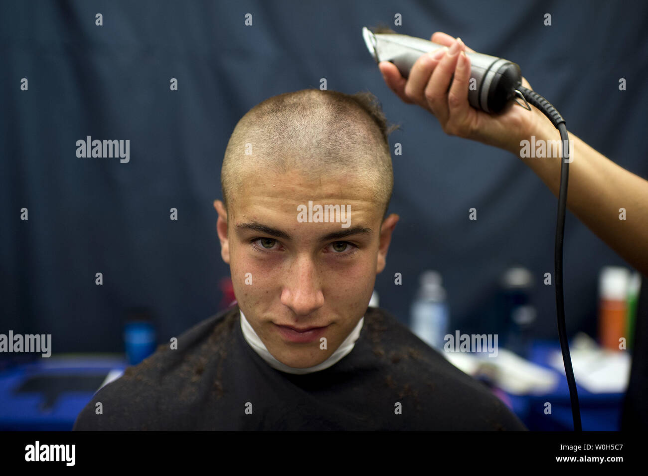Ryan Shows has his head shaved during Induction Day at the U.S. Naval ...
