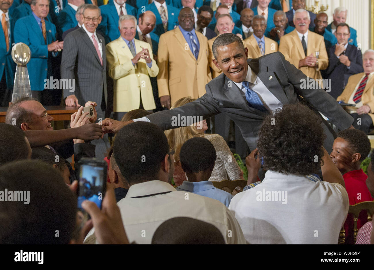 President Barack Obama greets a member of the audience during a ...