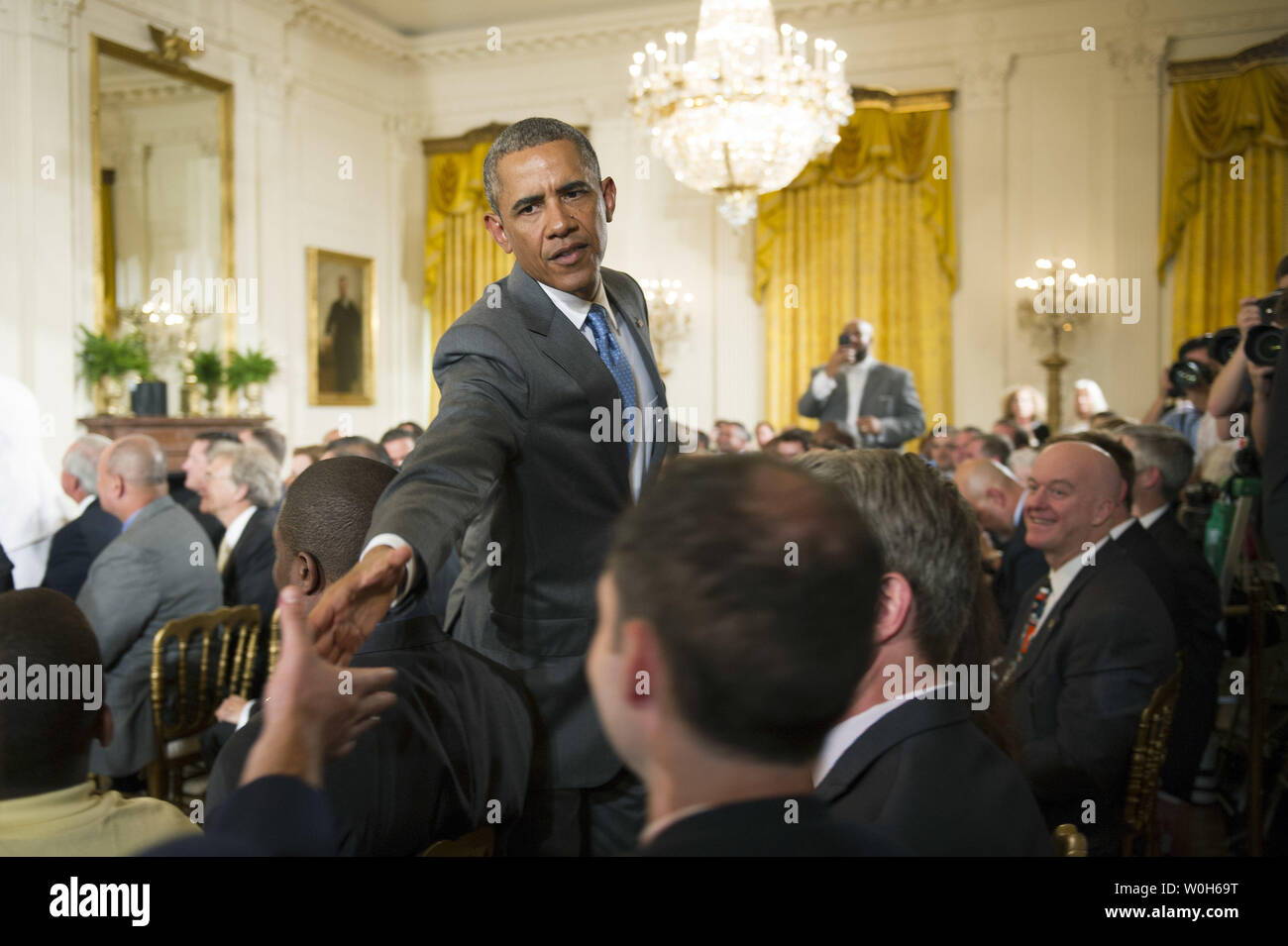 President Barack Obama greets a member of the audience during a ...