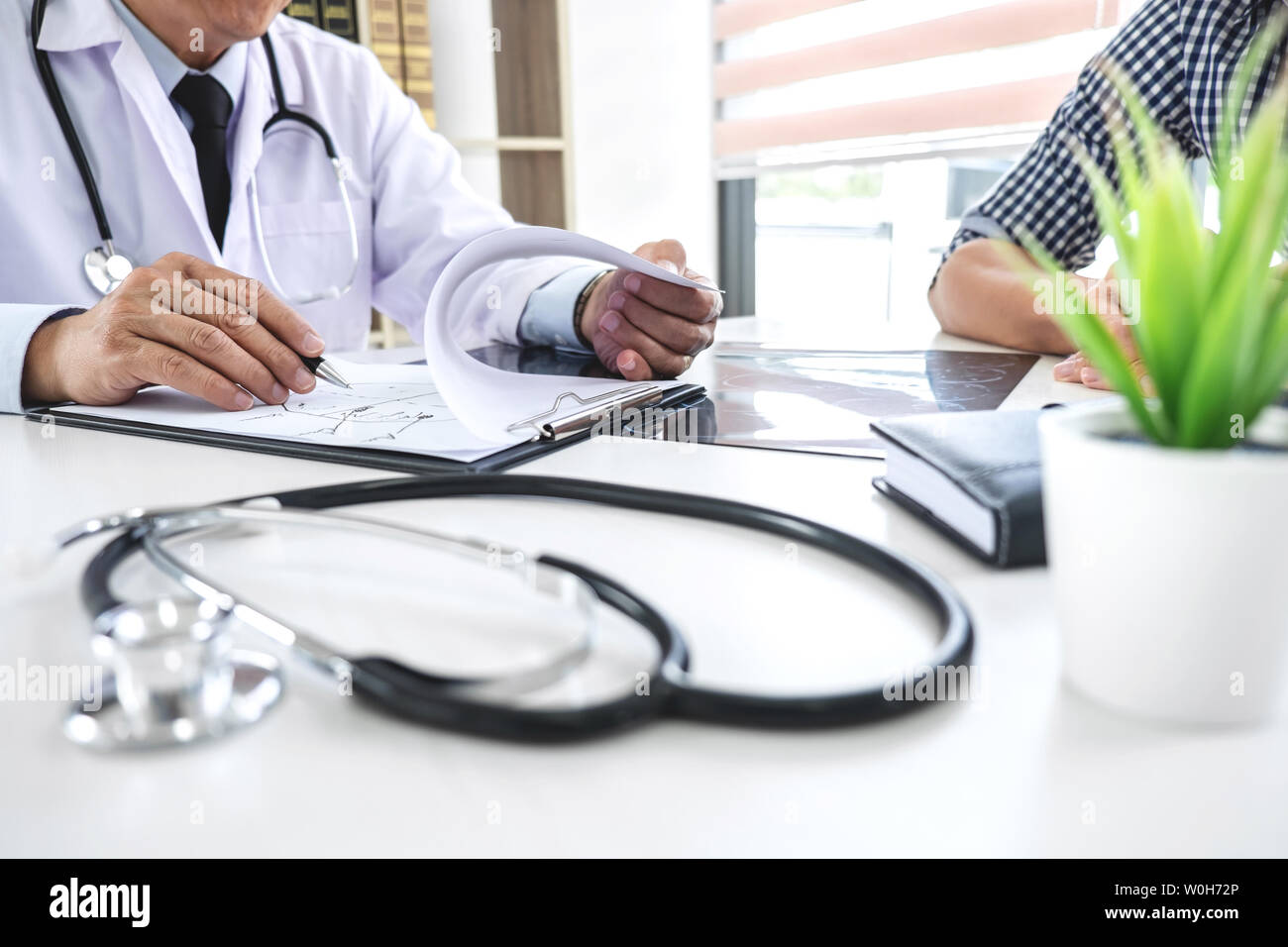 Professor Doctor having conversation with patient and holding x-ray ...
