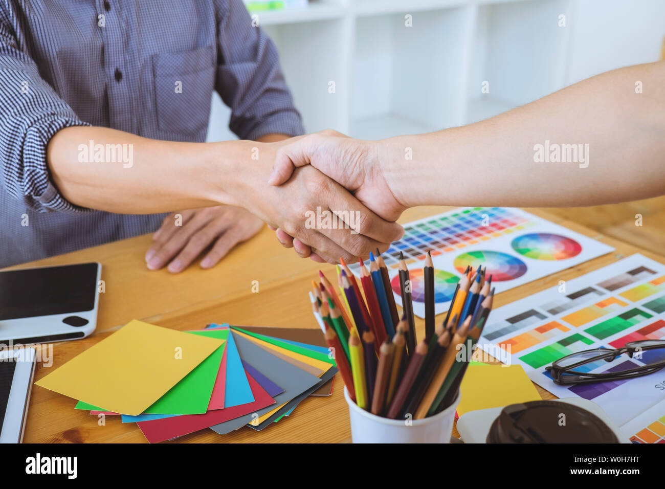 Cooperation of Young creative graphic designer working on workspace and ...