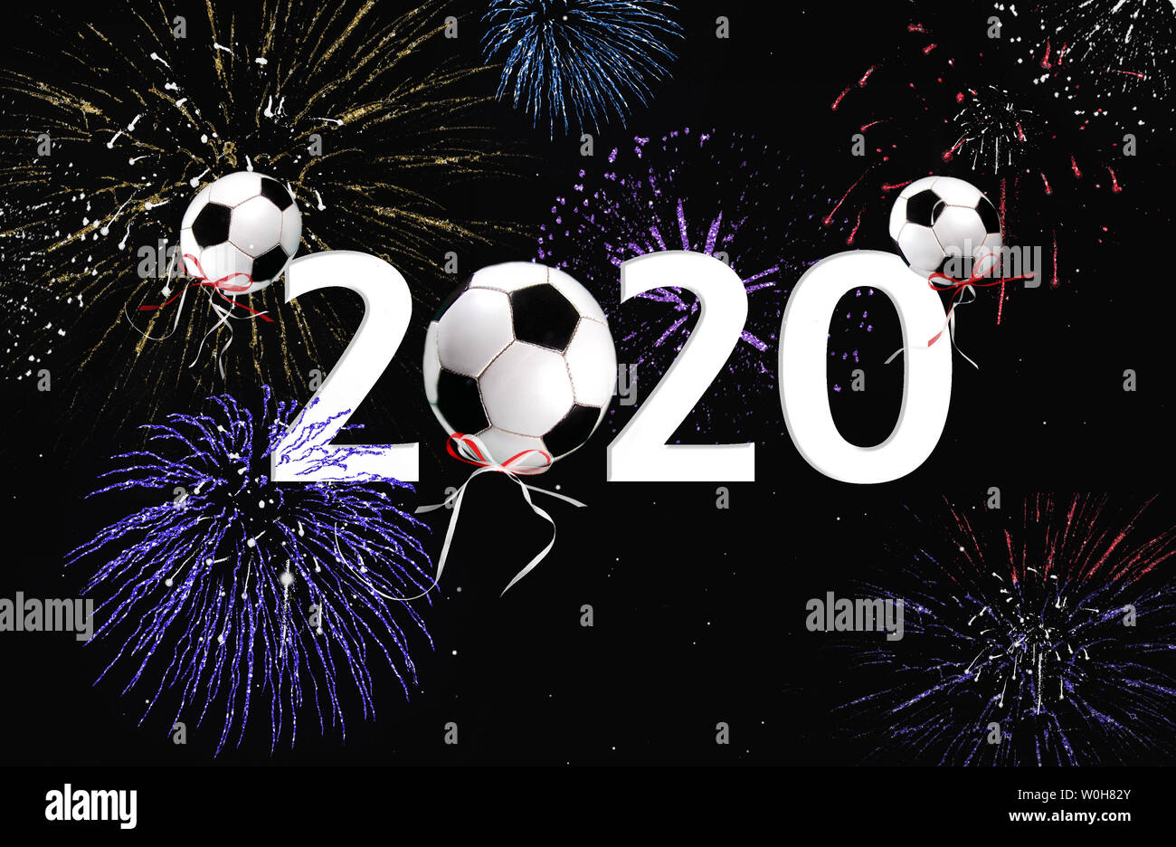 soccer ball balloons and fireworks in black sky for New Years 2020 ...