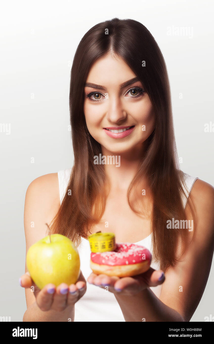 Diet. Emaciation. Girl smiles while holding an apple in her arms ...
