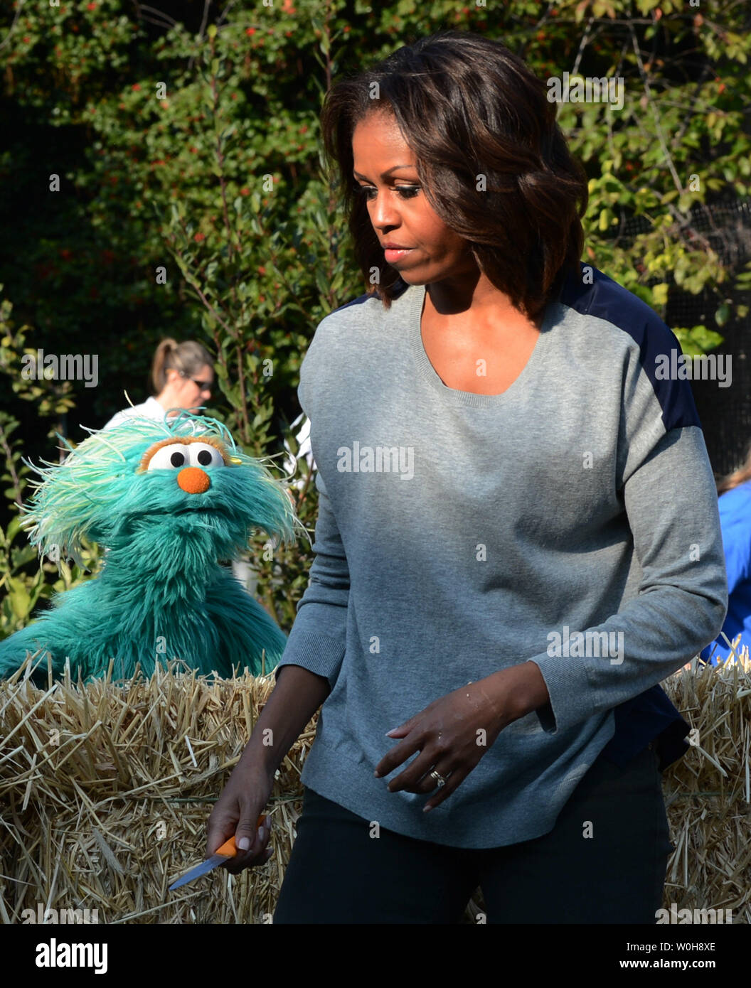 With Sesame Street's Rosita looking on, First Lady Michelle Obama digs ...