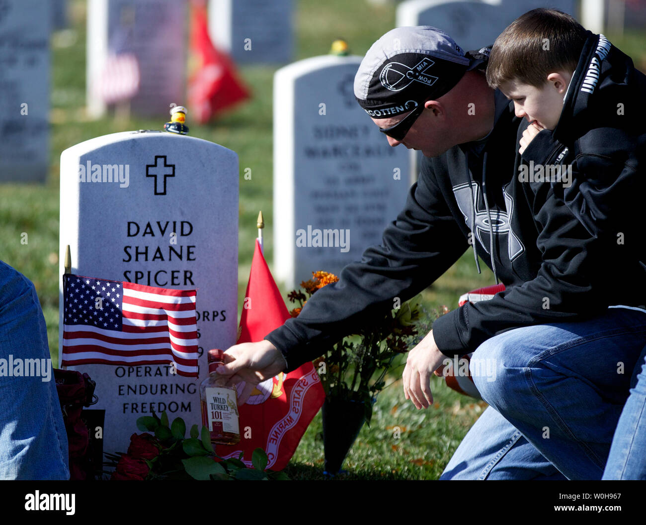 Michael Armstrong, with his son Michael Armstrong Jr., places a bottle ...