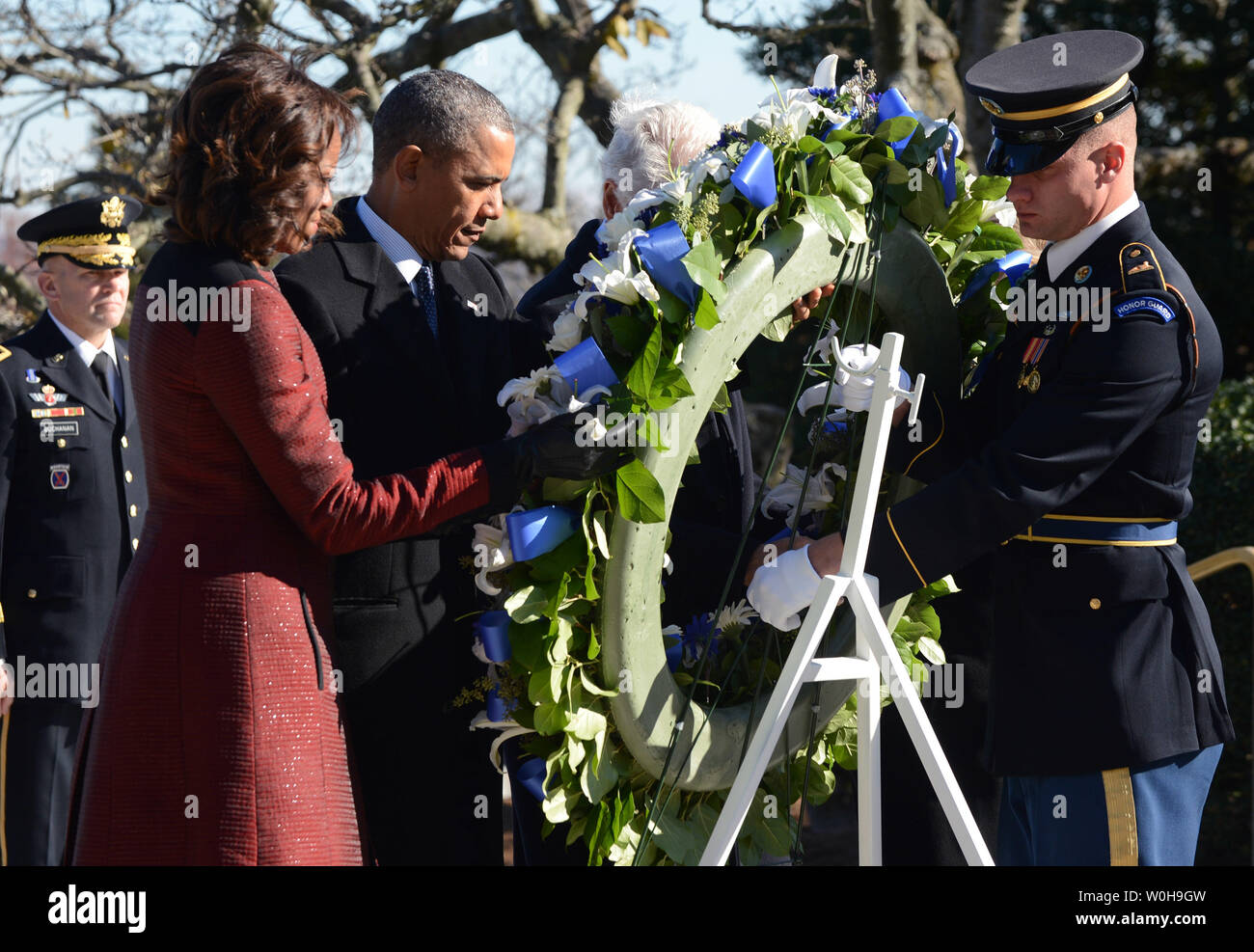 President Barack Obama and First Lady Michelle Obama lay a wreath at ...