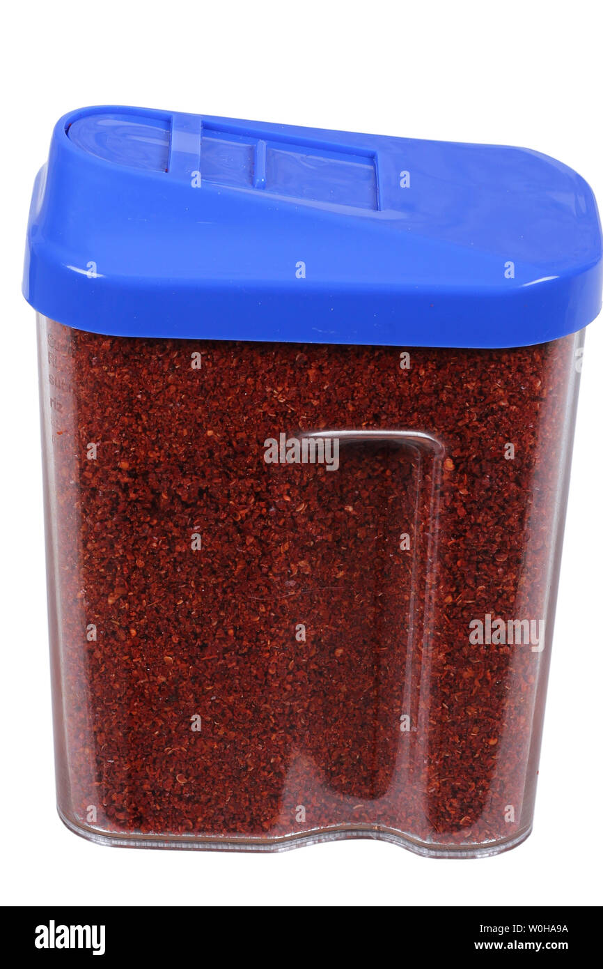 Chili powder in plastic container Stock Photo - Alamy