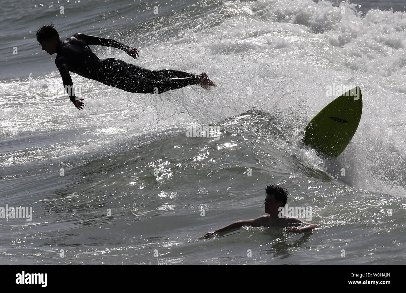 A surfer falls off their board as they surf off of Bournemouth beach in ...