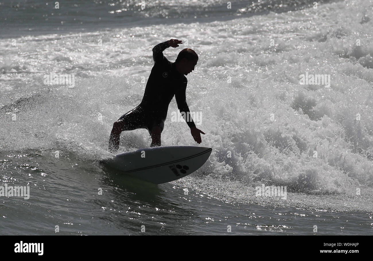 A surfer rides a wave off Bournemouth beach in Dorset Stock Photo - Alamy
