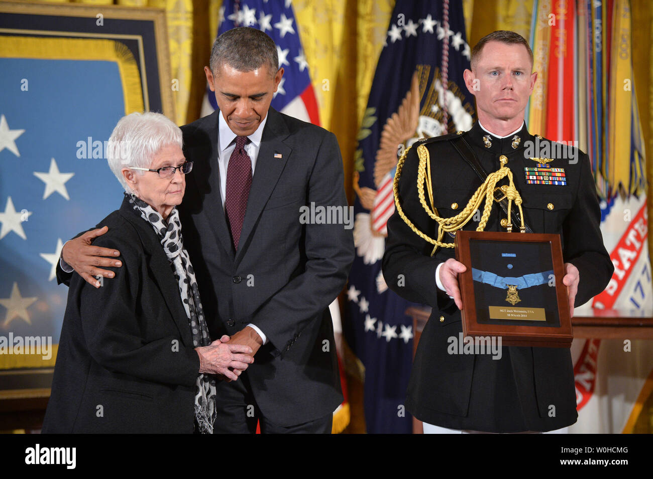President Barack Obama embraces Nancy Weinstein as she accepts the ...